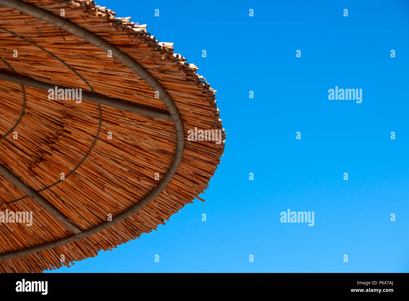 Straw roof of sun umbrella against the blue sky. Vacation topic.summer ...