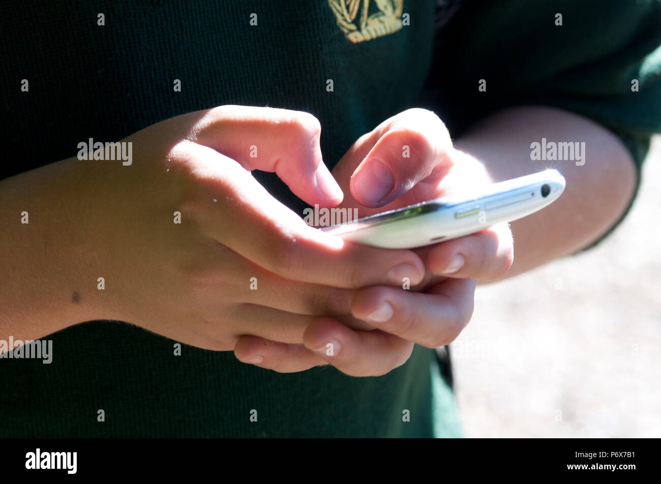 Schoolboy using a mobile phone Stock Photo - Alamy