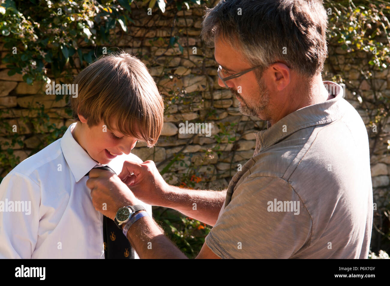 Father helping his son with his school tie Stock Photo - Alamy