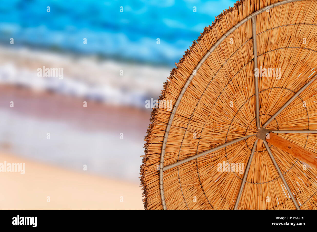 Reed umbrellas beach Stock Photo - Alamy