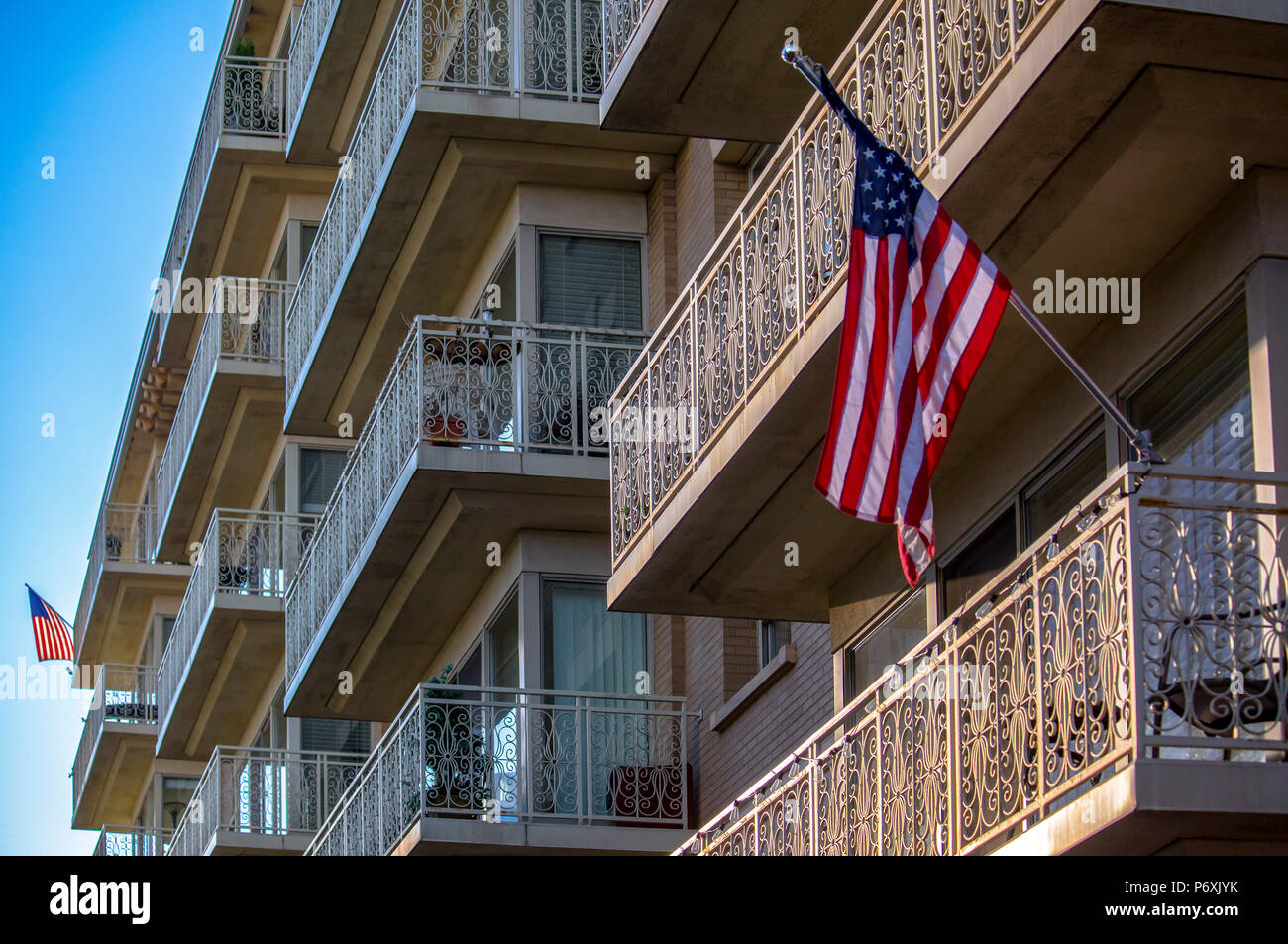 American flags on the side of building Stock Photo - Alamy
