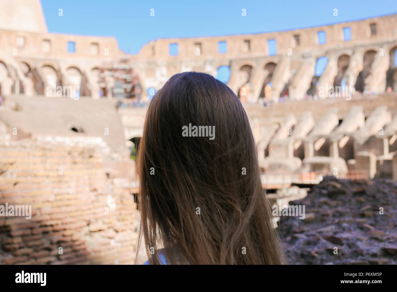Closeup back view of female tourist inside Colosseum in Rome, Italy ...
