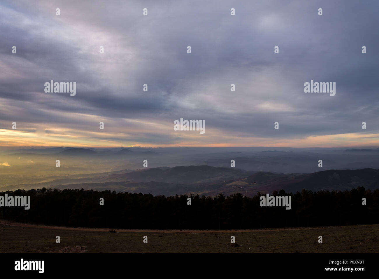 Subasio Mt. (Umbria, Italy), with sky covered by clouds and warm sunset ...