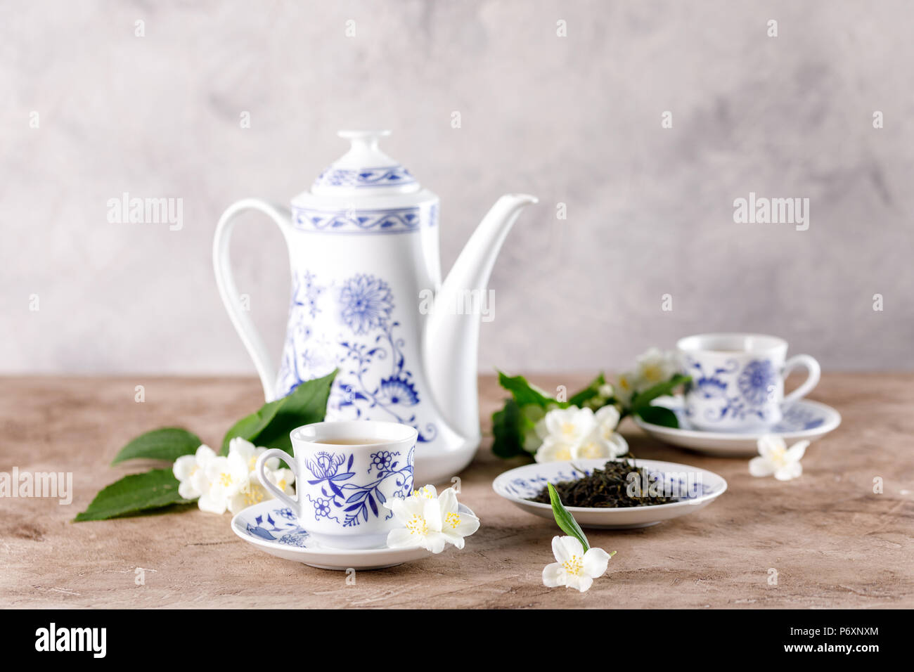 Green tea with jasmine. A beautiful tea set. Still-life with jasmine ...