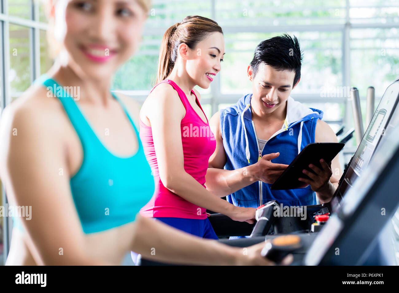 Supervision of sportive people training on treadmill Stock Photo - Alamy