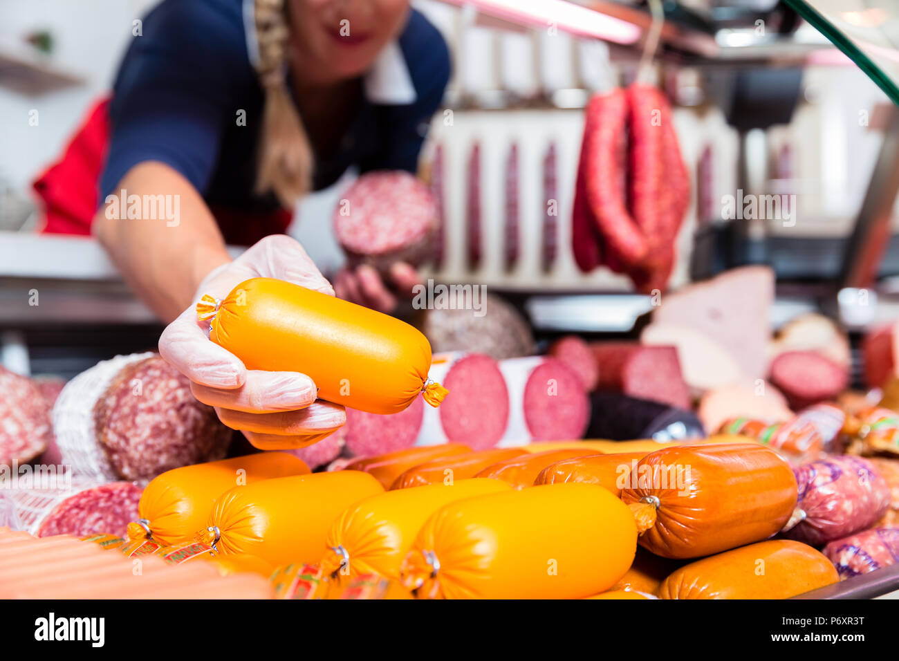 Butcher shop woman holding meat in her hand Stock Photo - Alamy