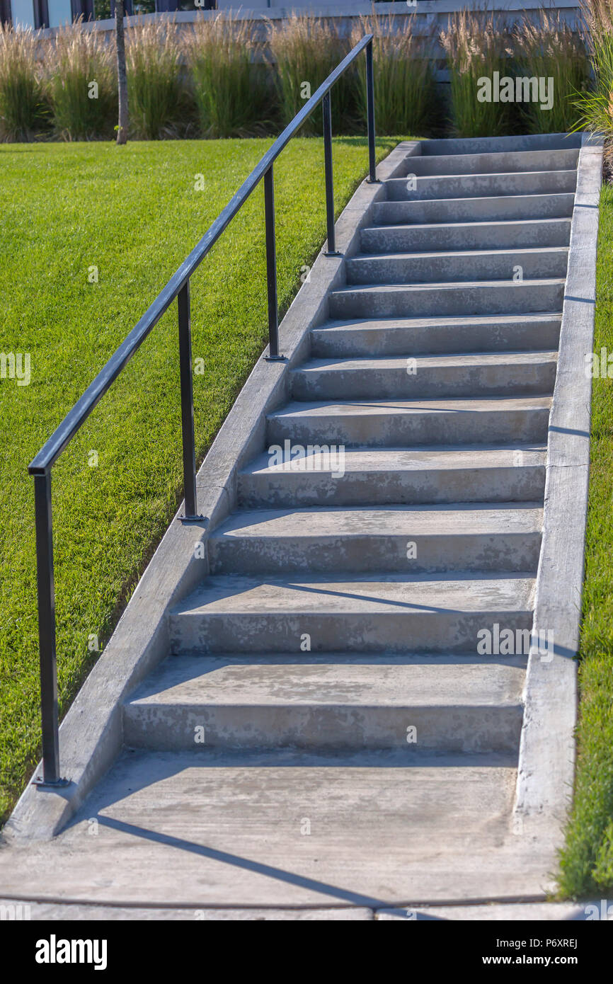 Concrete stairs in community area with lawn Stock Photo - Alamy