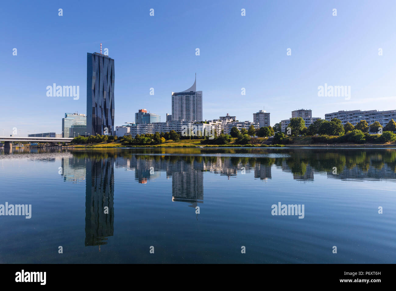 Austria, Vienna, Donau City reflecting in New Danube River Stock Photo ...