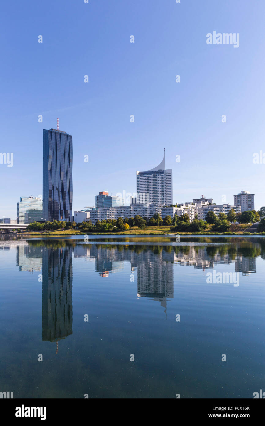 Austria, Vienna, Donau City reflecting in New Danube River Stock Photo ...