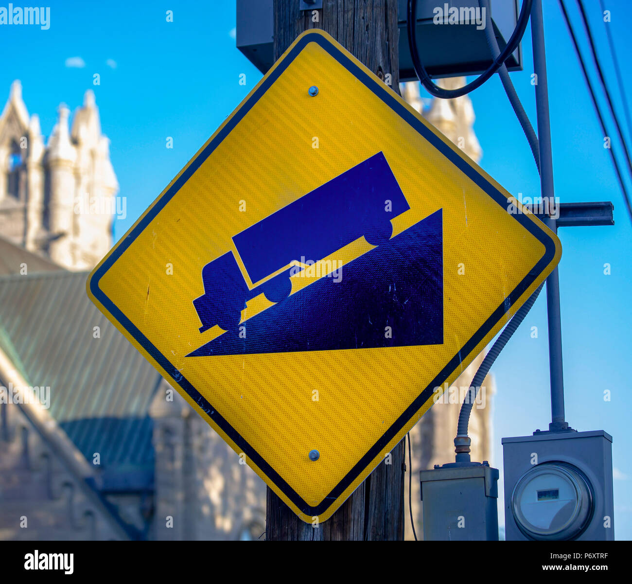 Downhill warning sign for trucks in downtown Stock Photo - Alamy