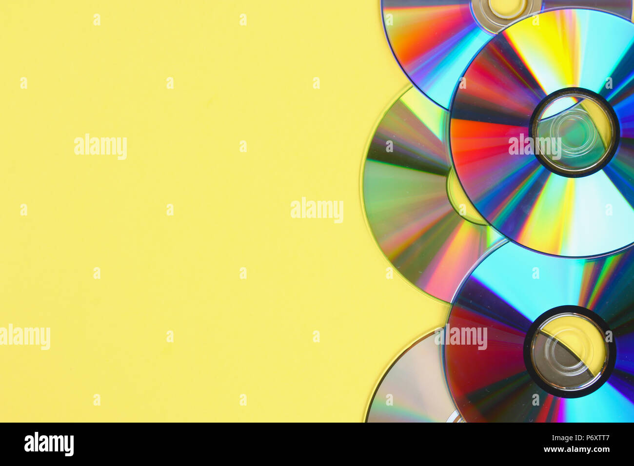 Piles of old and dirty CDs,DVD on pastel background. Used and dusty ...