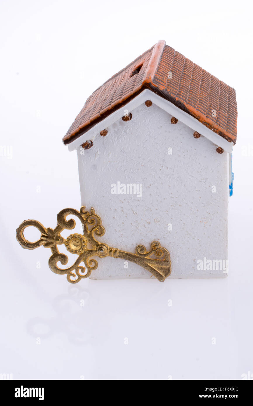 Key near a house on a white background Stock Photo - Alamy