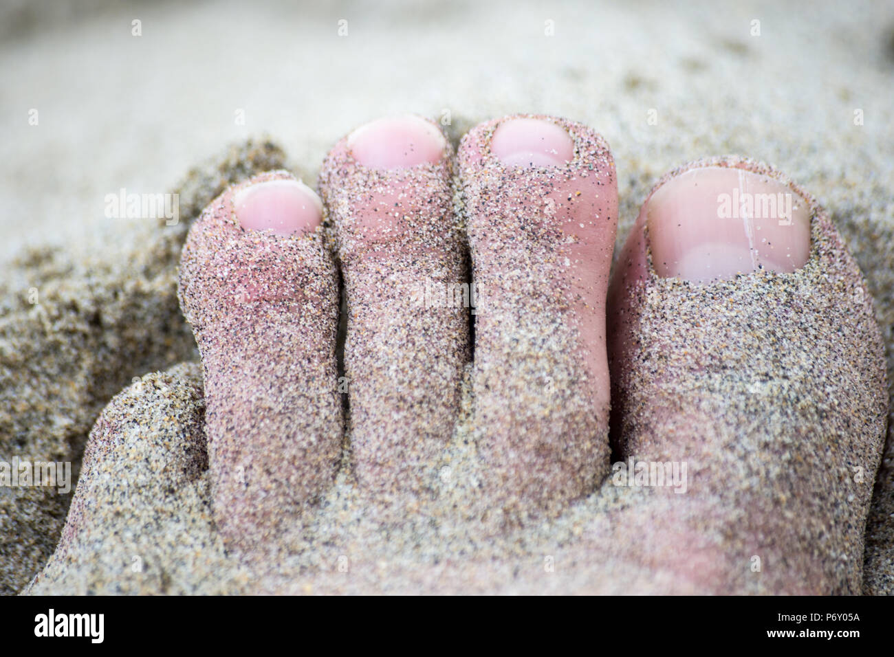 Feet in the sand Stock Photo - Alamy