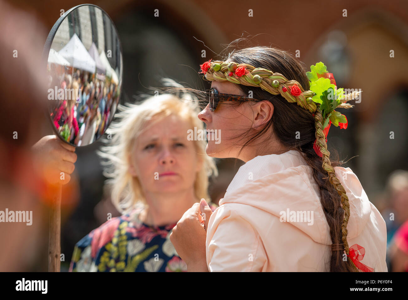 RIGA, LATVIA - JUNE 22, 2018: Summer solstice market. The woman looks ...