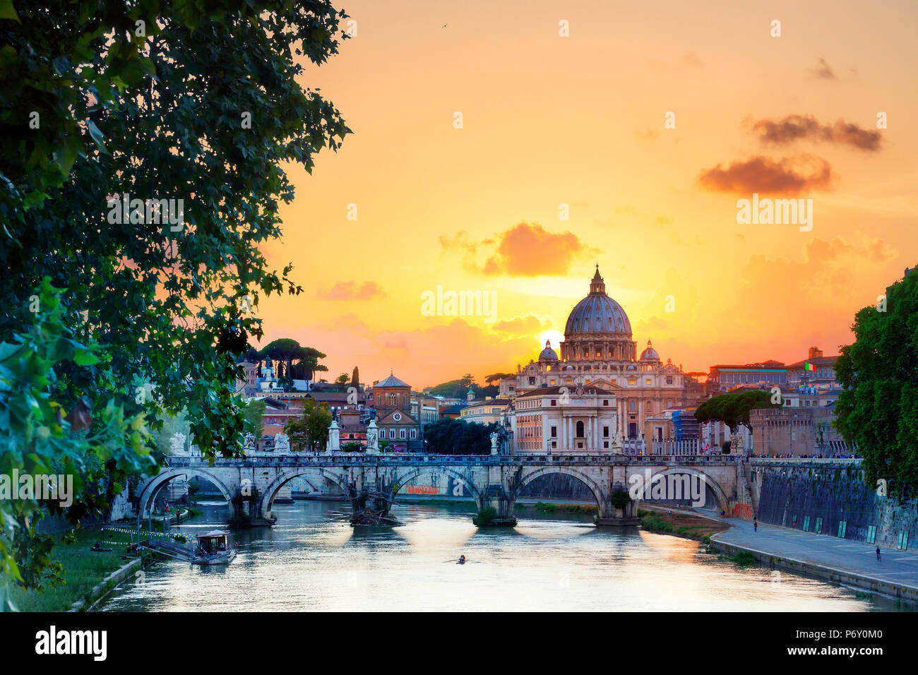 Italy, Rome, St. Peter Basilica at sunset reflecting on Tevere river ...