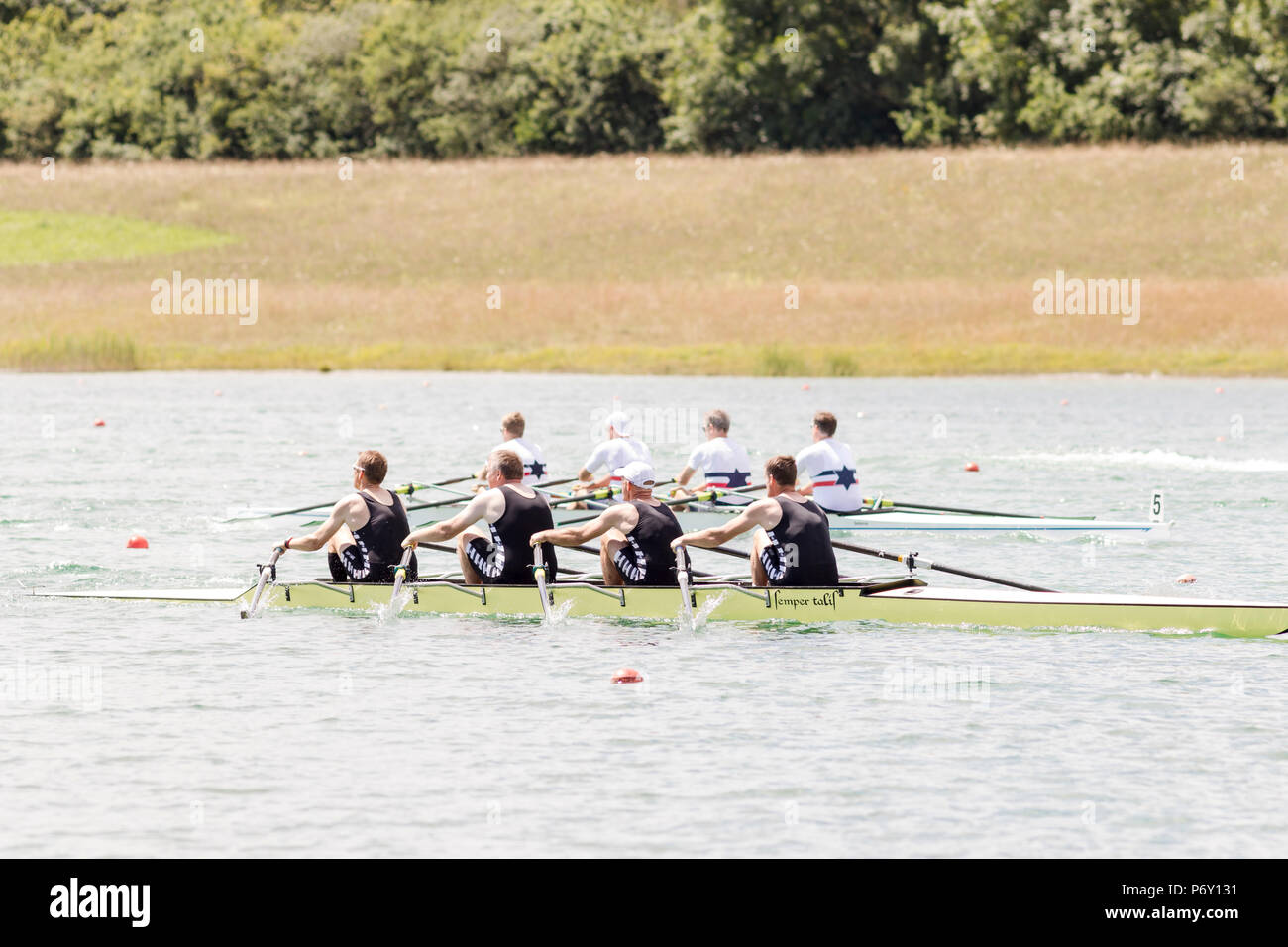 Rowers in rowing boats on the tranquil lake Stock Photo - Alamy