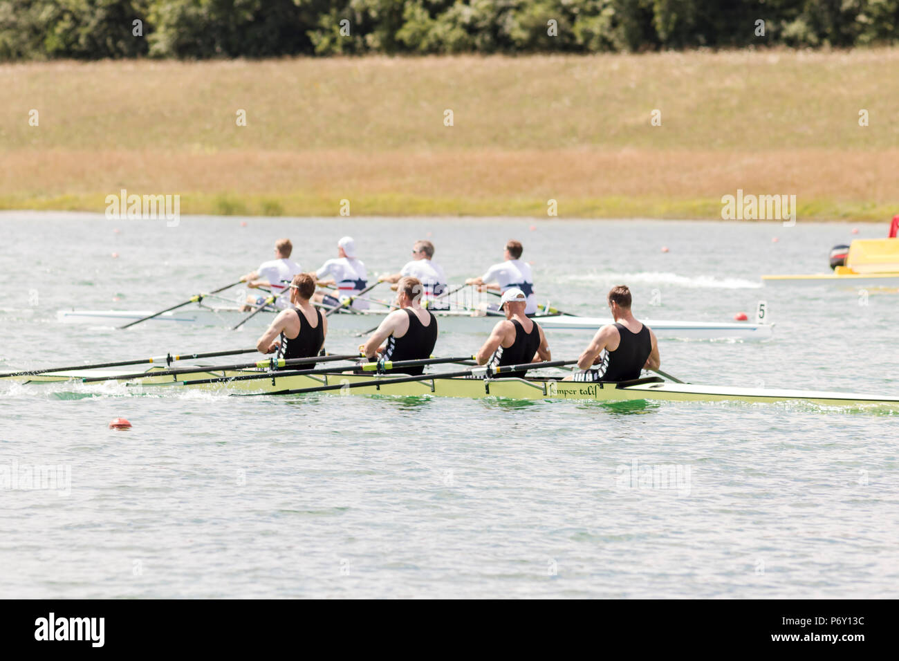Rowers in rowing boats on the tranquil lake Stock Photo - Alamy
