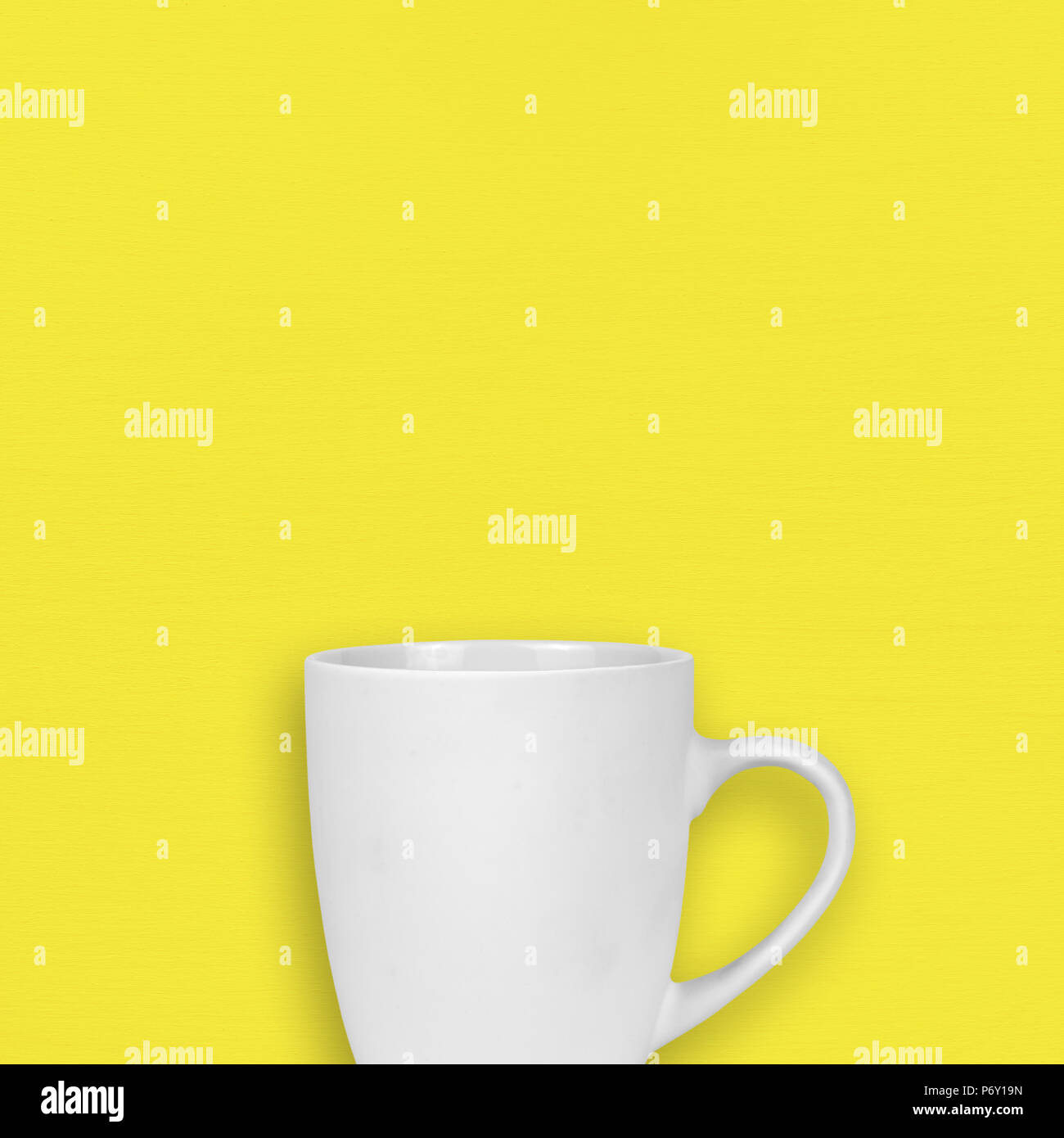 White mug on yellow background Stock Photo - Alamy