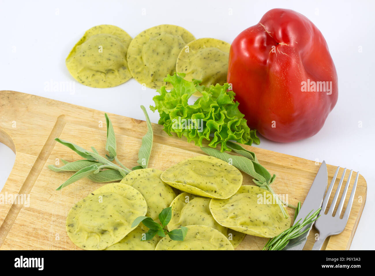 italian pasta ravioli with green herb on wood white background ...