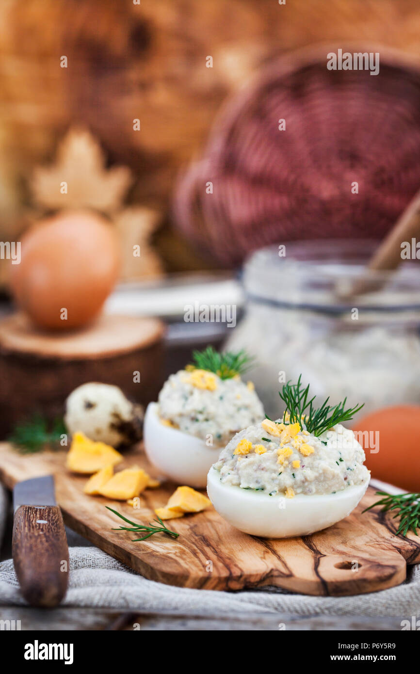 Eggs stuffed with herring creamy pate on wooden rustic background Stock ...