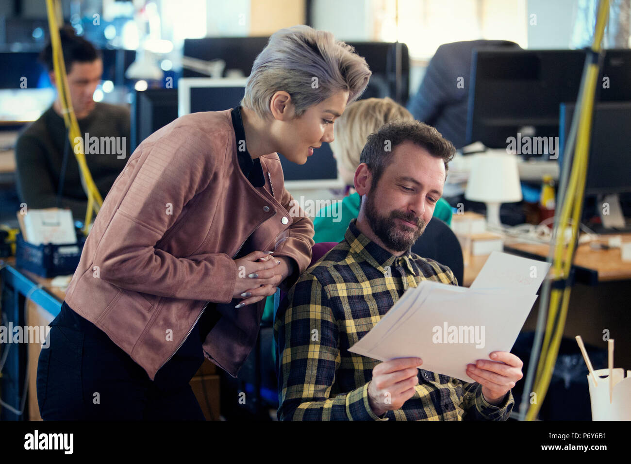 Creative business people discussing paperwork in office Stock Photo - Alamy