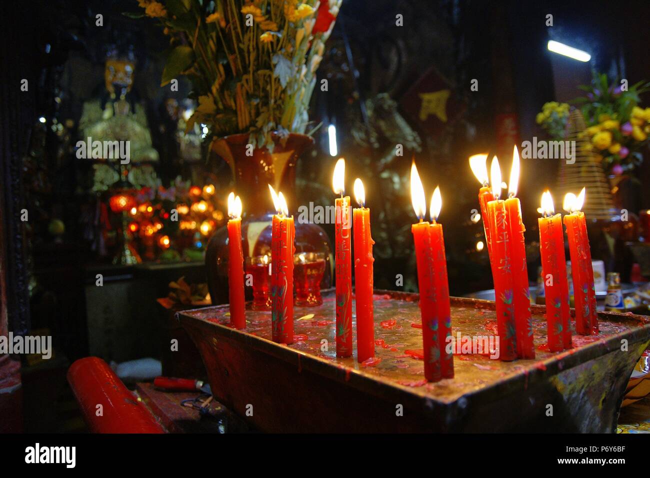 Red candles melted in temple Stock Photo - Alamy