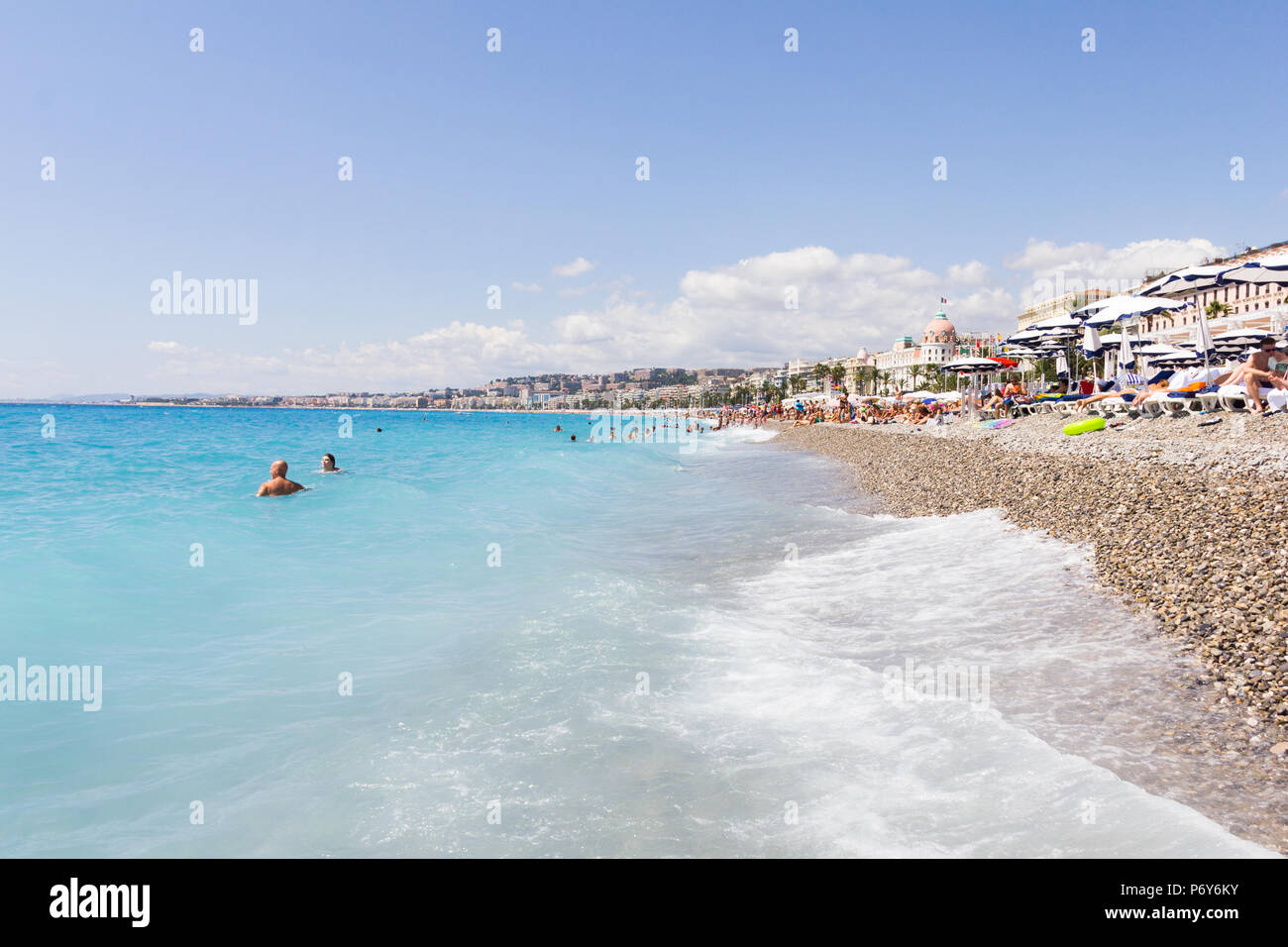 NICE, FRANCE - AUGUST 23: Tourists enjoy the good weather at the beach ...