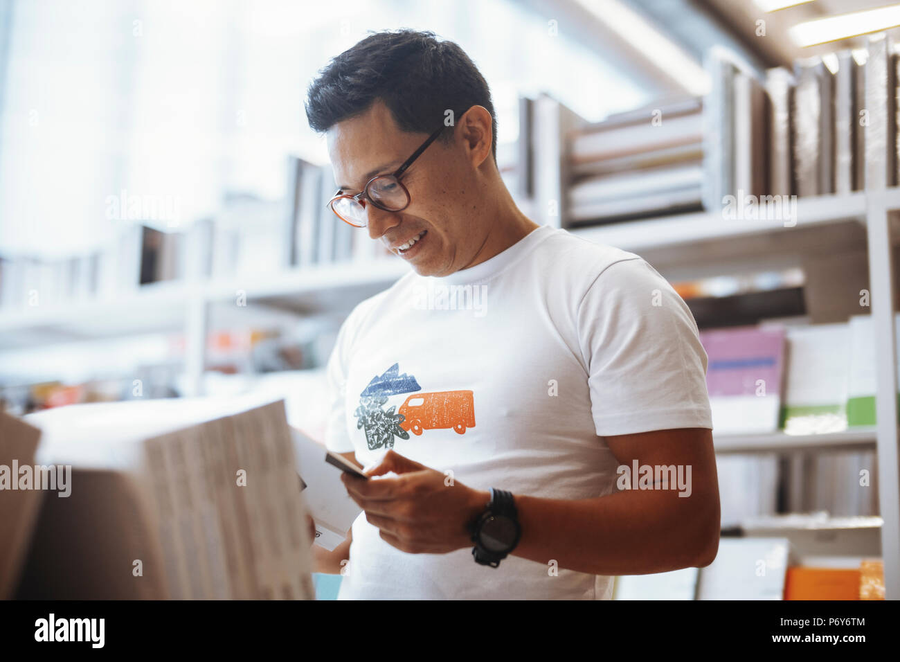 Happy young man reading paper hi-res stock photography and images - Alamy