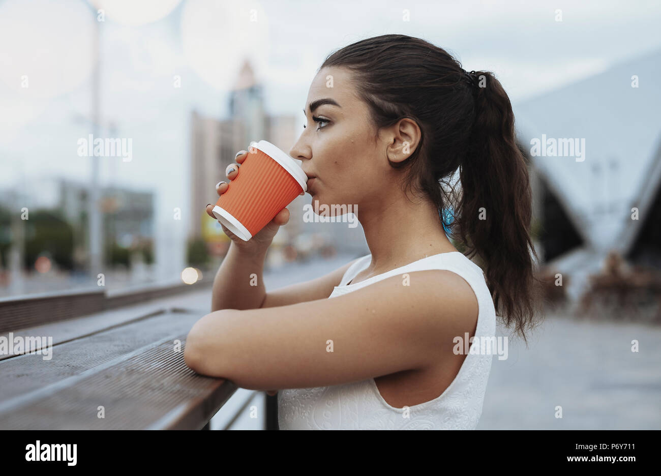 Young attractive woman drinking coffee Stock Photo - Alamy