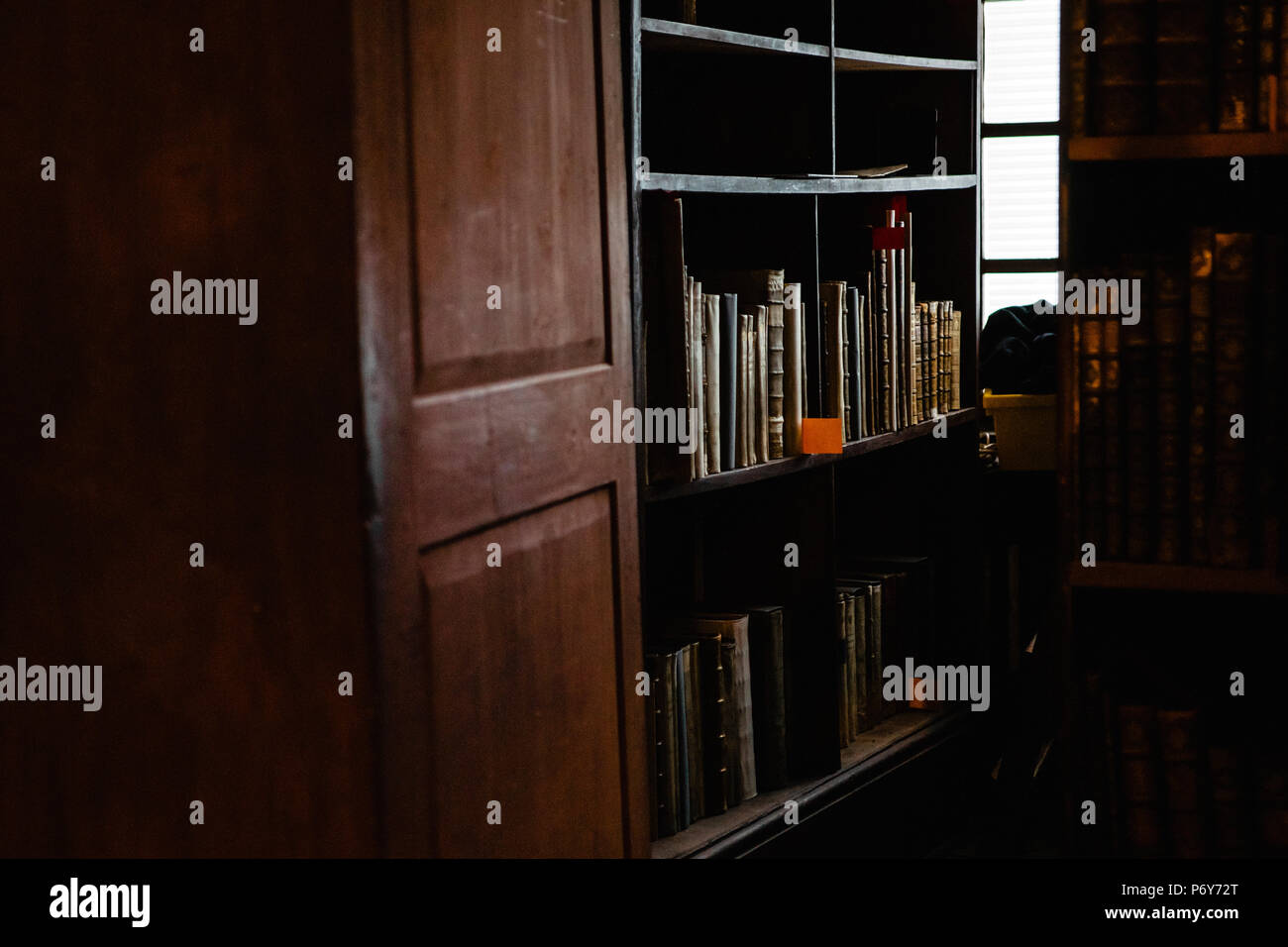 Old library, little illuminated and gilded Stock Photo - Alamy