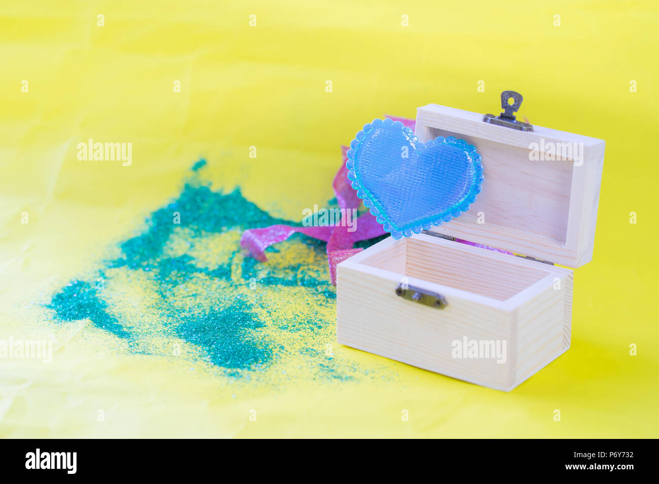 blue heart on gift box wooden and yellow paper background Stock Photo ...