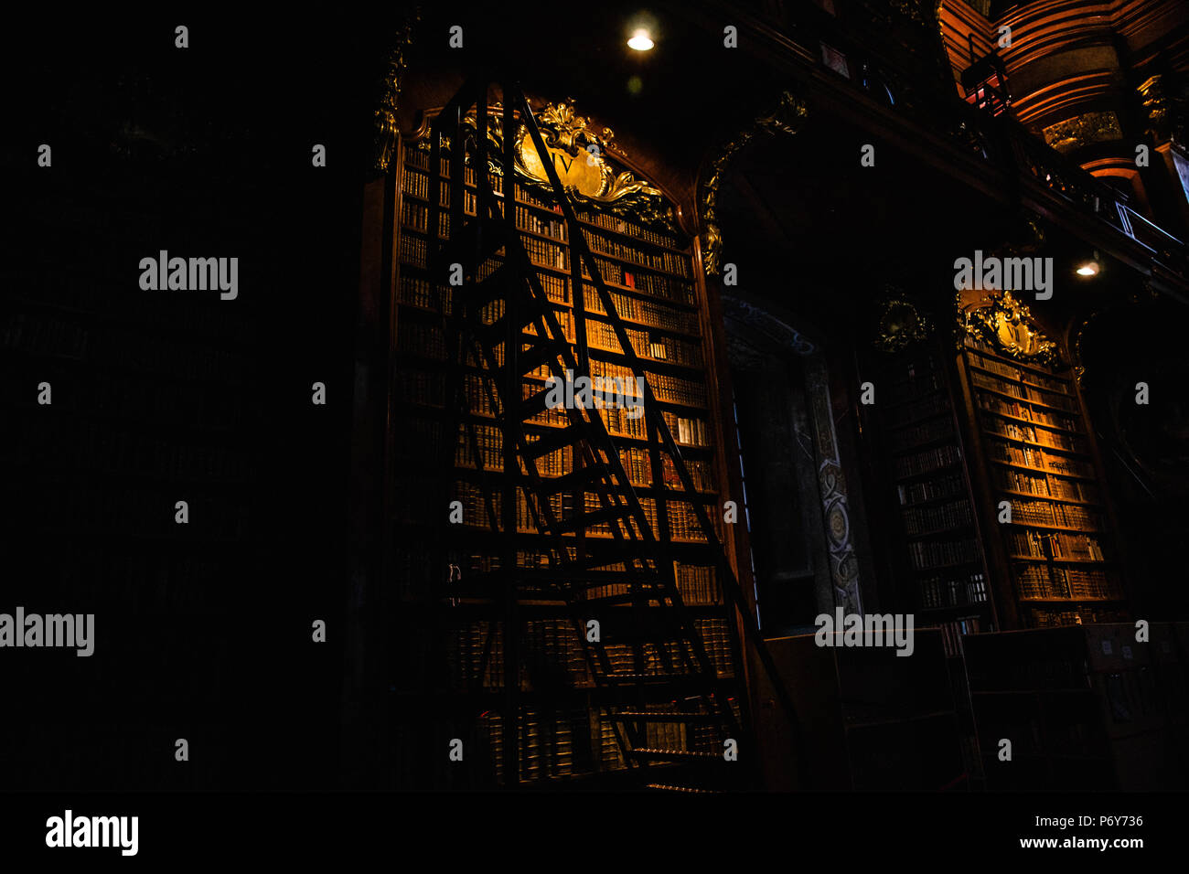 Old library, little illuminated and gilded Stock Photo - Alamy