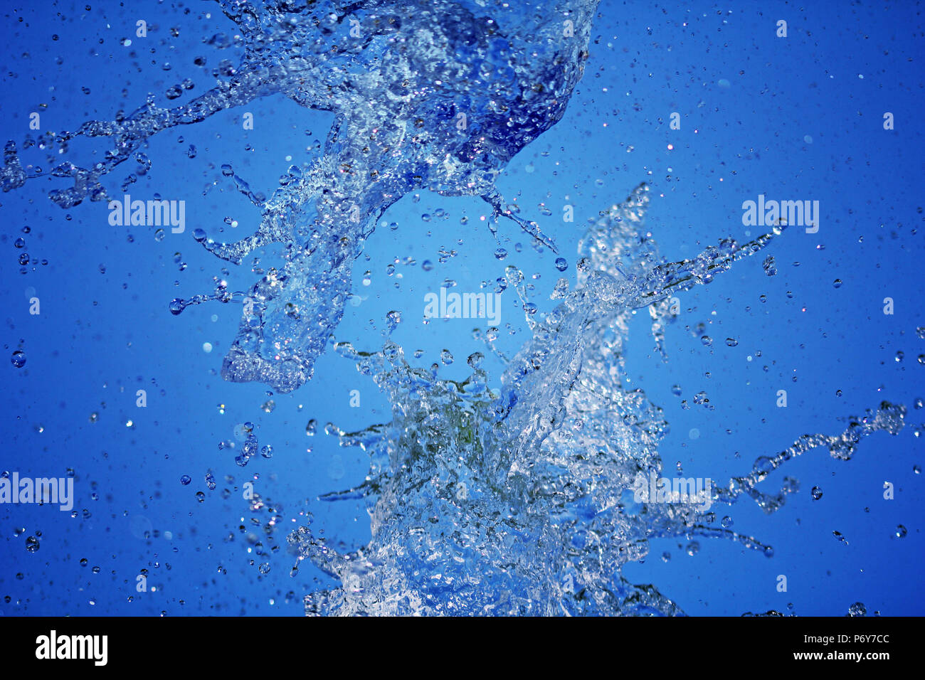 Water splash on blue background close up shoot Stock Photo - Alamy