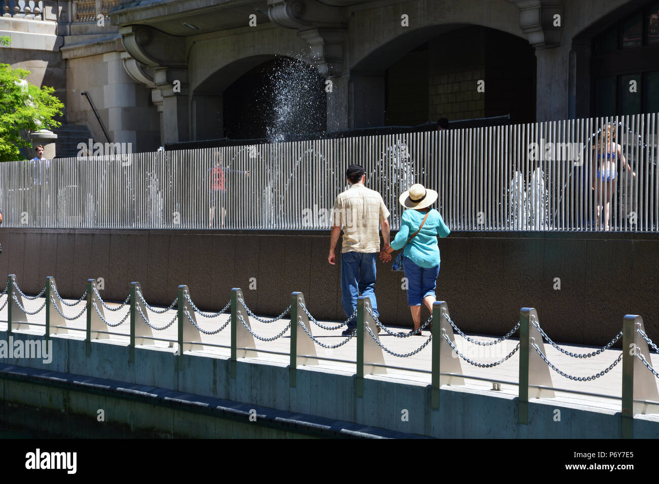 A couple walks along the waterfall ledge of a section the Chicago ...