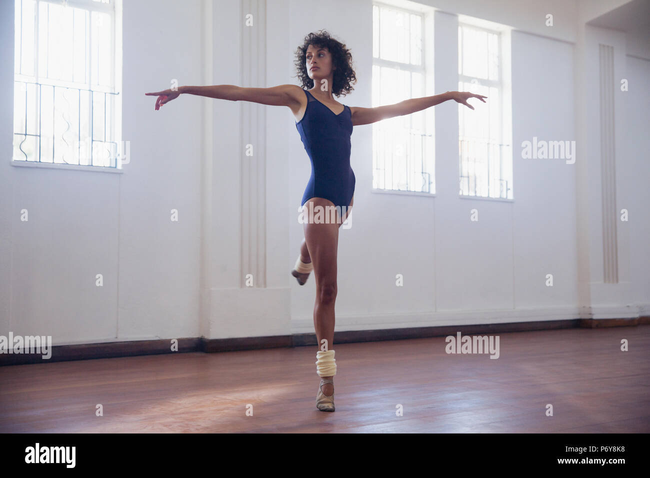 Female ballet dancer on one leg with arms outstretched hi-res stock ...