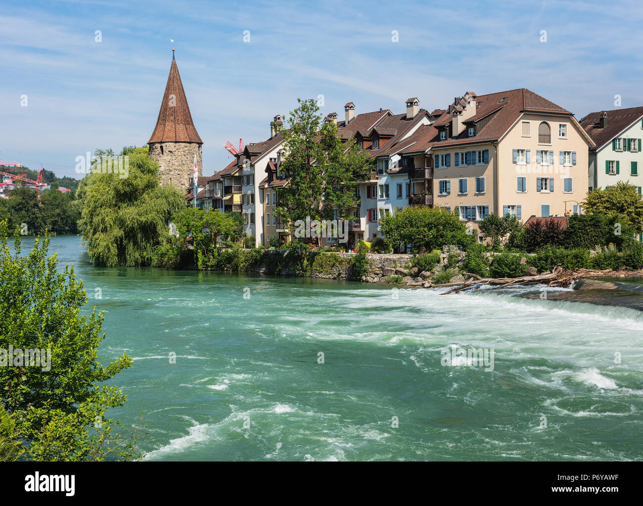 View along the Reuss river in the town of Bremgarten in the Swiss ...