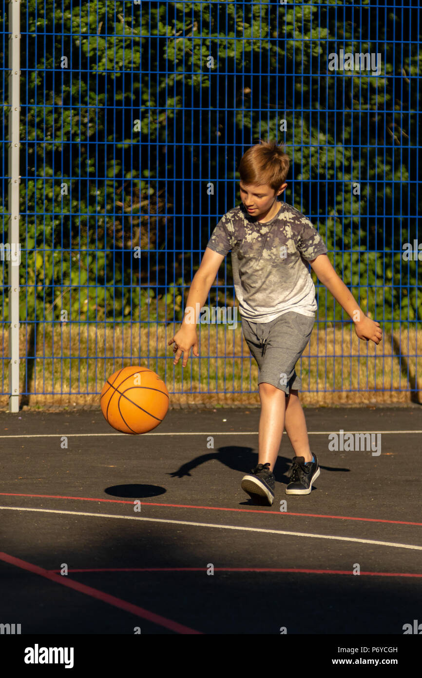 Boy playing basketball hi-res stock photography and images - Alamy