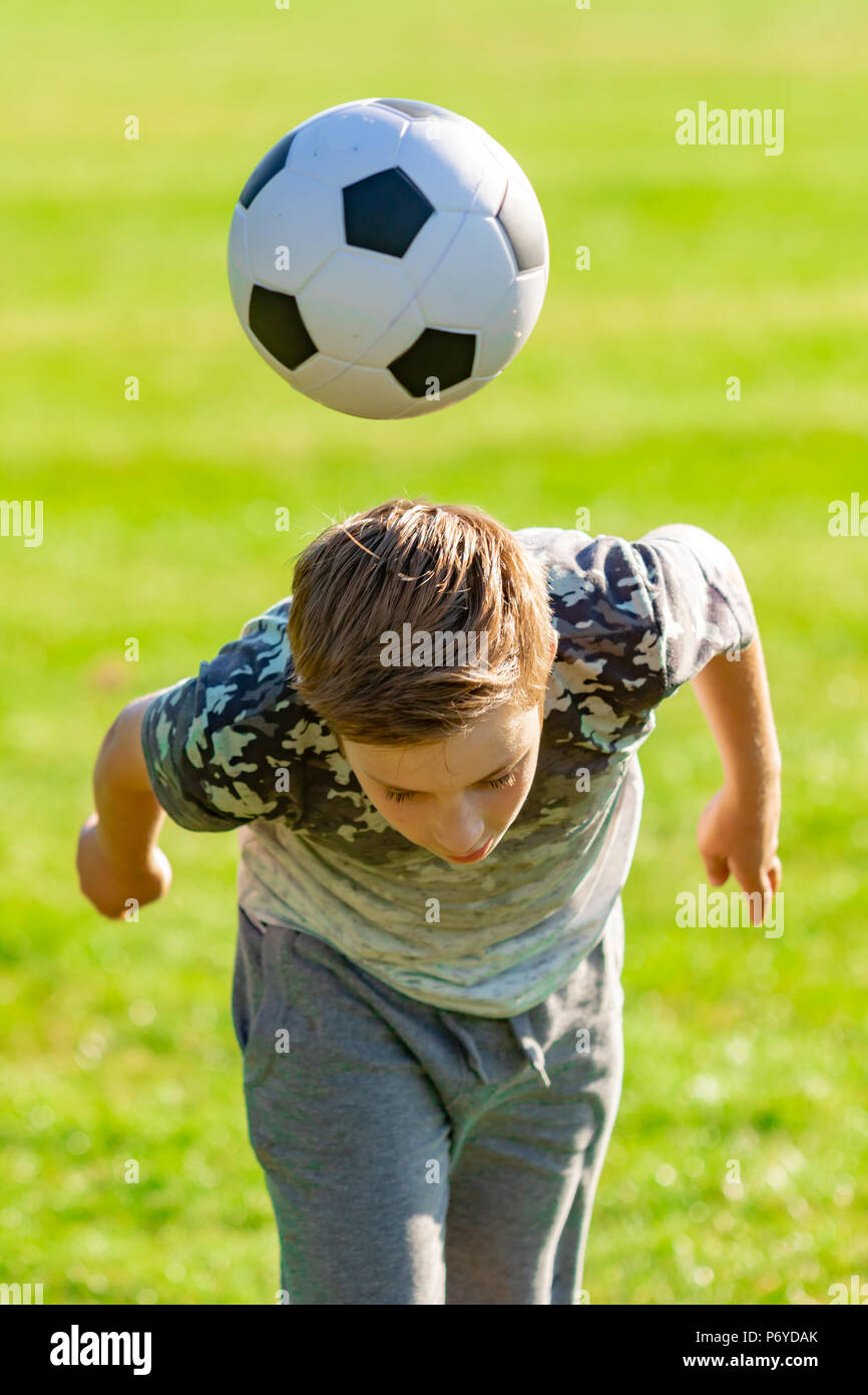 Football header boy hi-res stock photography and images - Alamy