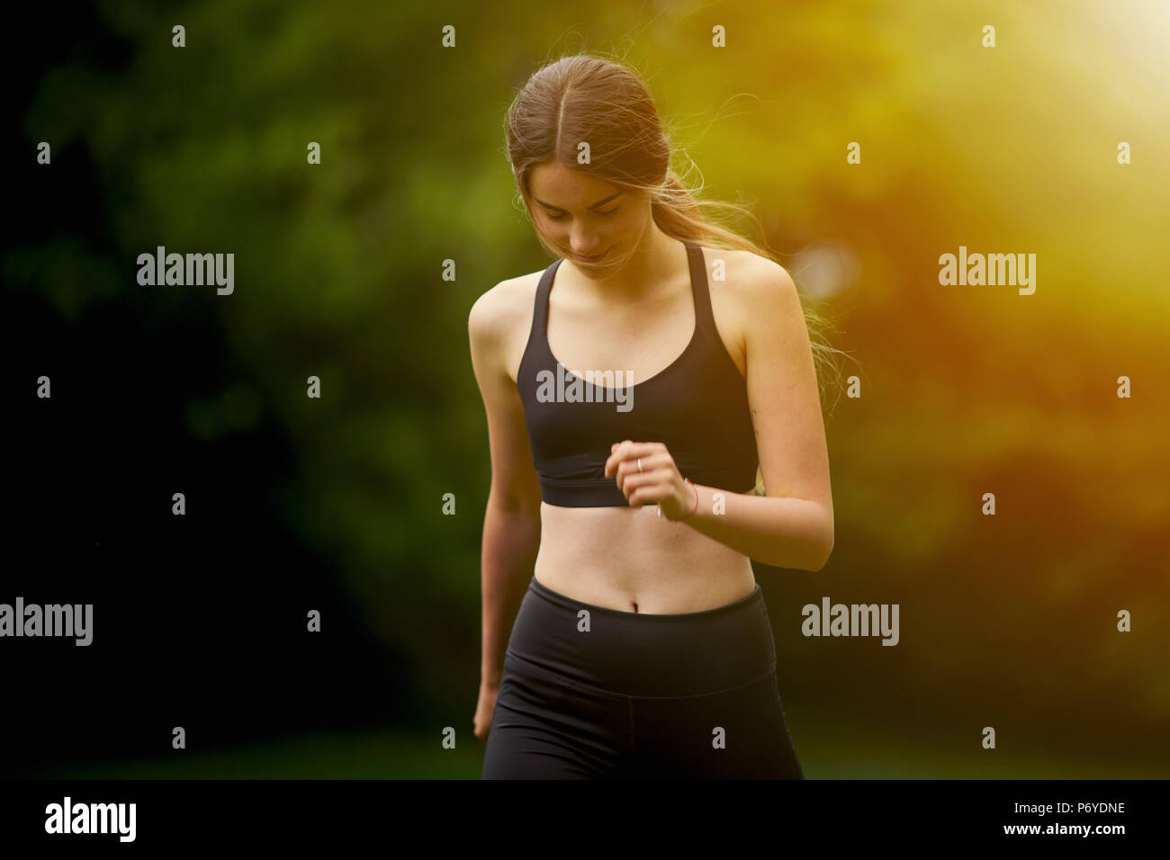 Fit pretty girl running on the park Stock Photo - Alamy
