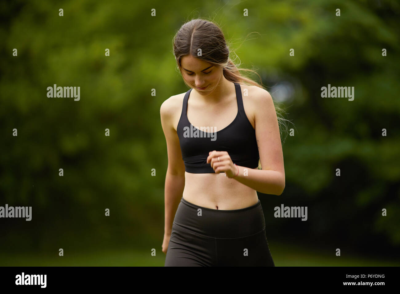 Fit pretty girl running on the park Stock Photo - Alamy
