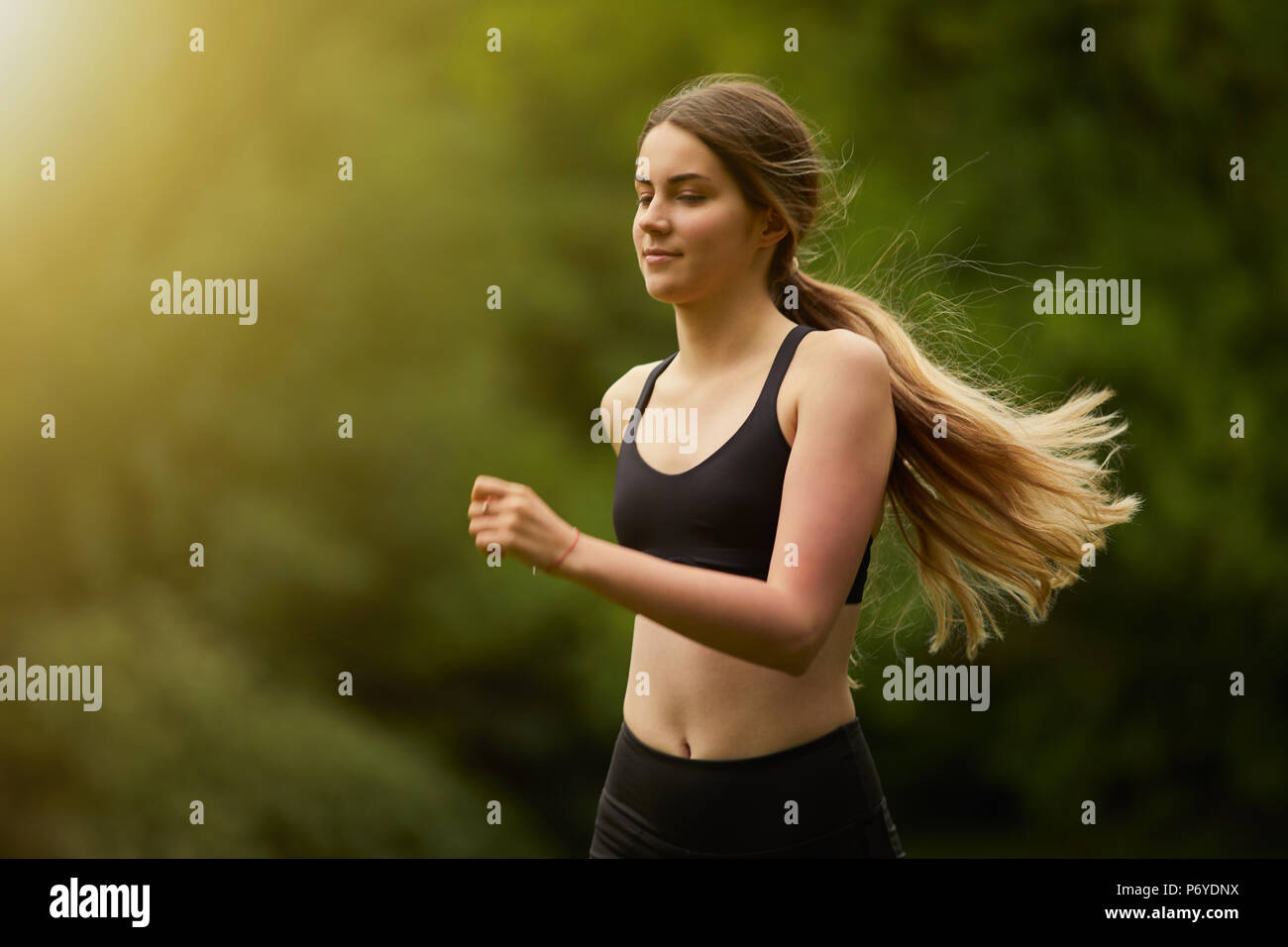 Fit pretty girl running on the park Stock Photo - Alamy