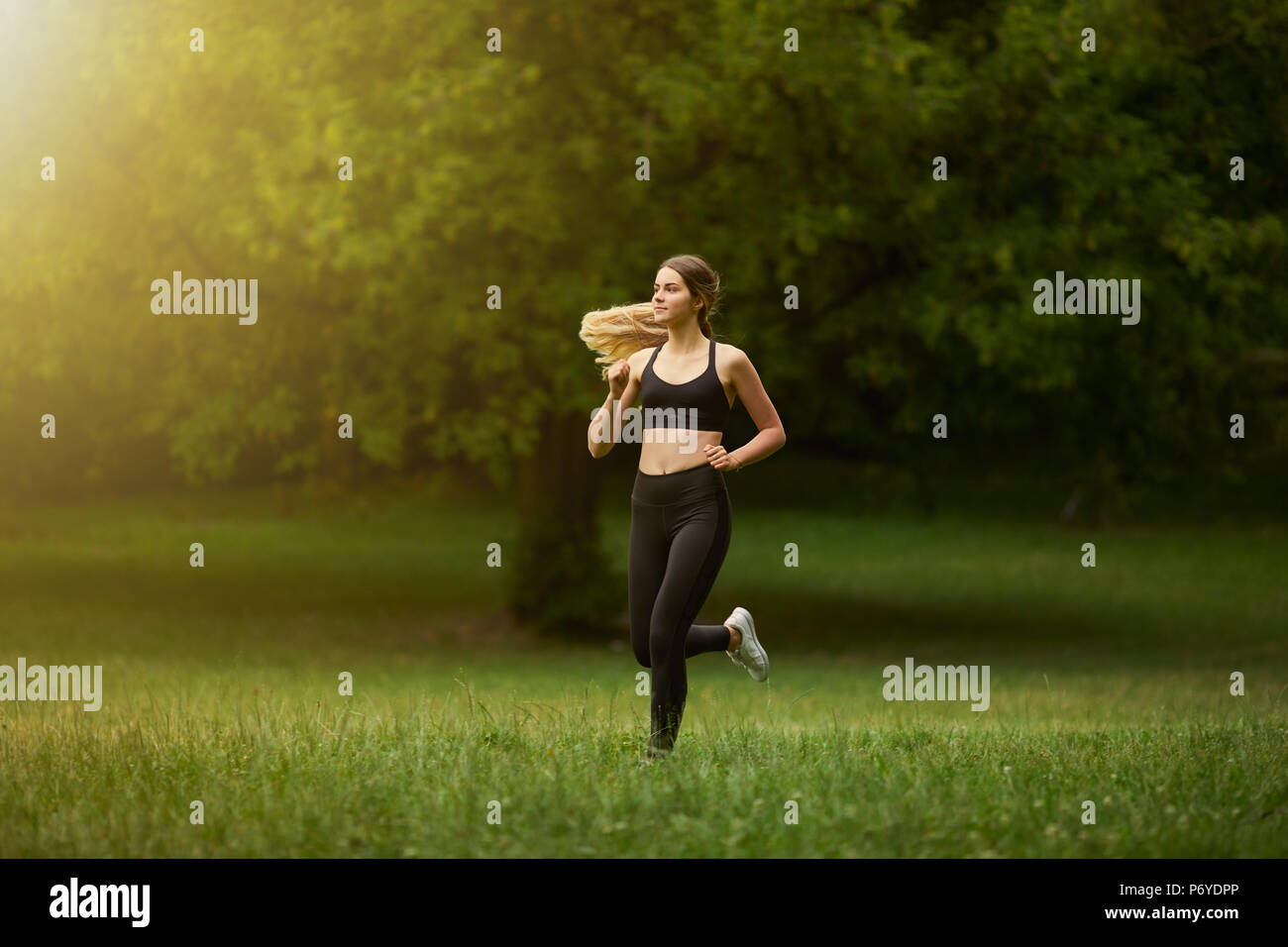 Fit pretty girl running on the park Stock Photo - Alamy