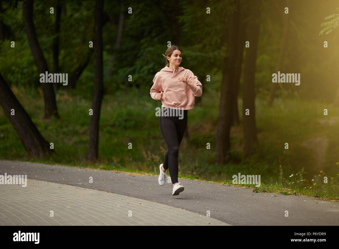 Fit pretty girl running on the park Stock Photo - Alamy
