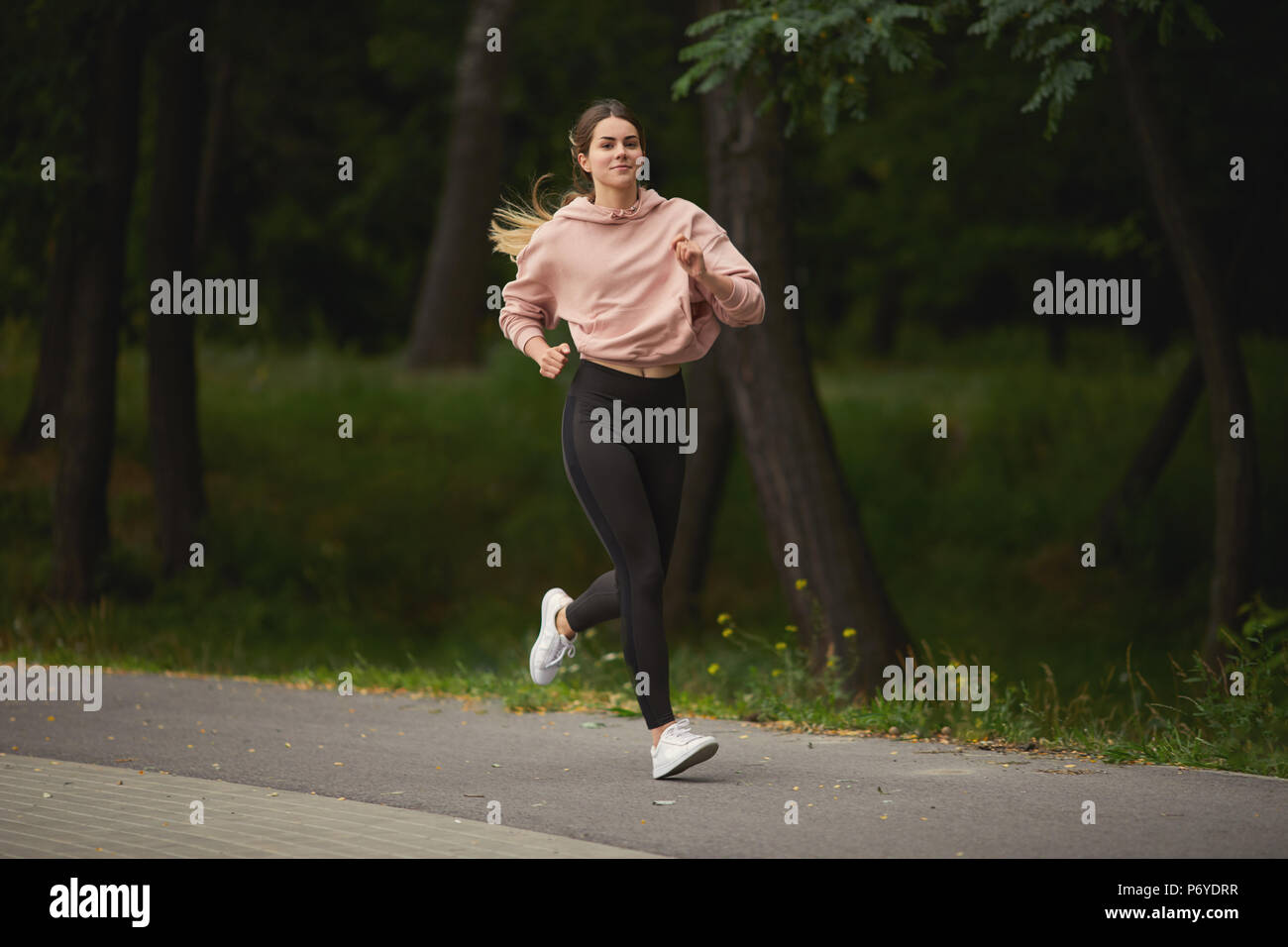 Fit pretty girl running on the park Stock Photo - Alamy