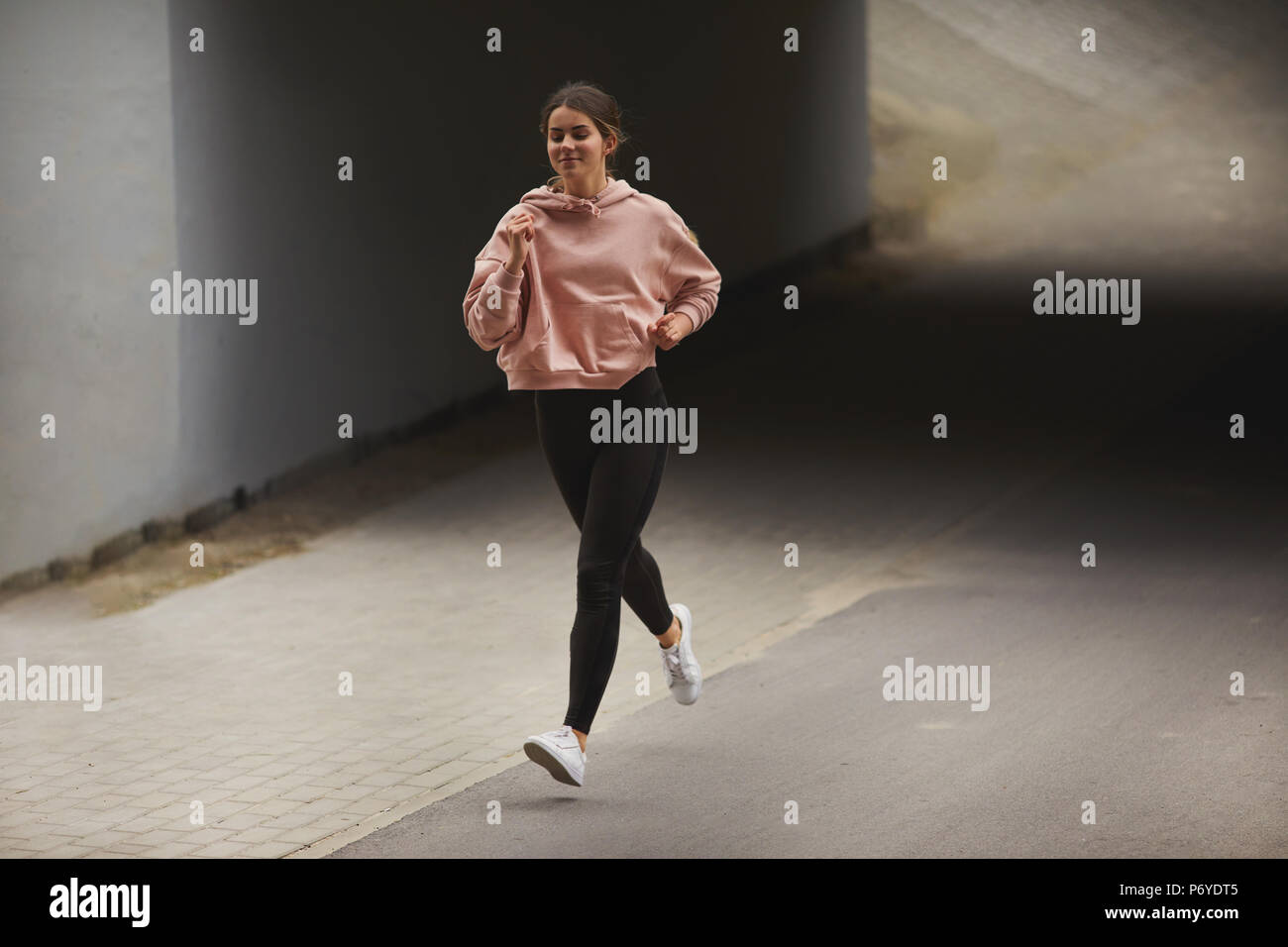 Sporty girl run on the street with night city baclkground Stock Photo ...