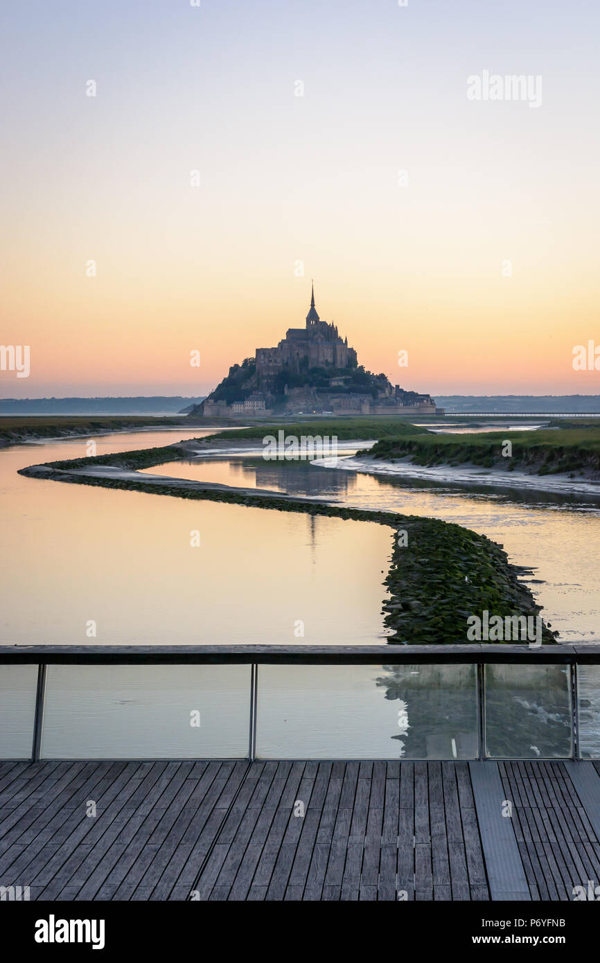 The Mont Saint-Michel tidal island at sunrise and high tide with the ...