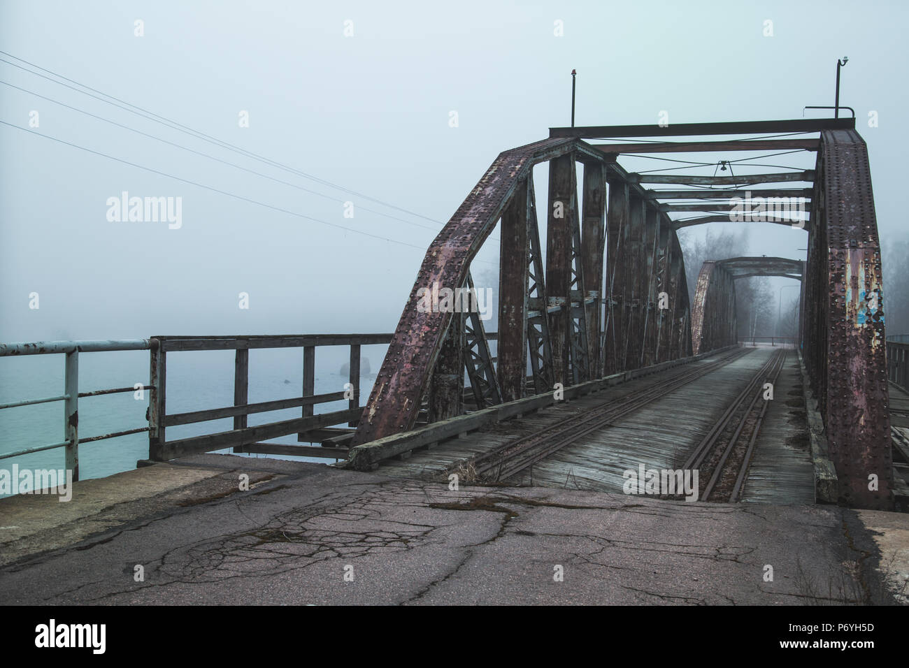 Old, abandoned railroad bridge in misty evening light Stock Photo - Alamy