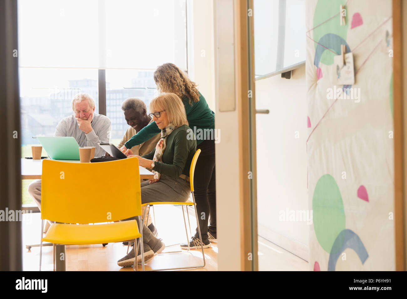 Senior business people using laptops in conference room meeting Stock ...