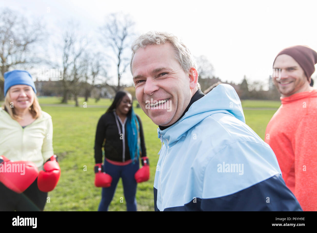 Portrait smiling, confident man boxing with friends in park Stock Photo ...