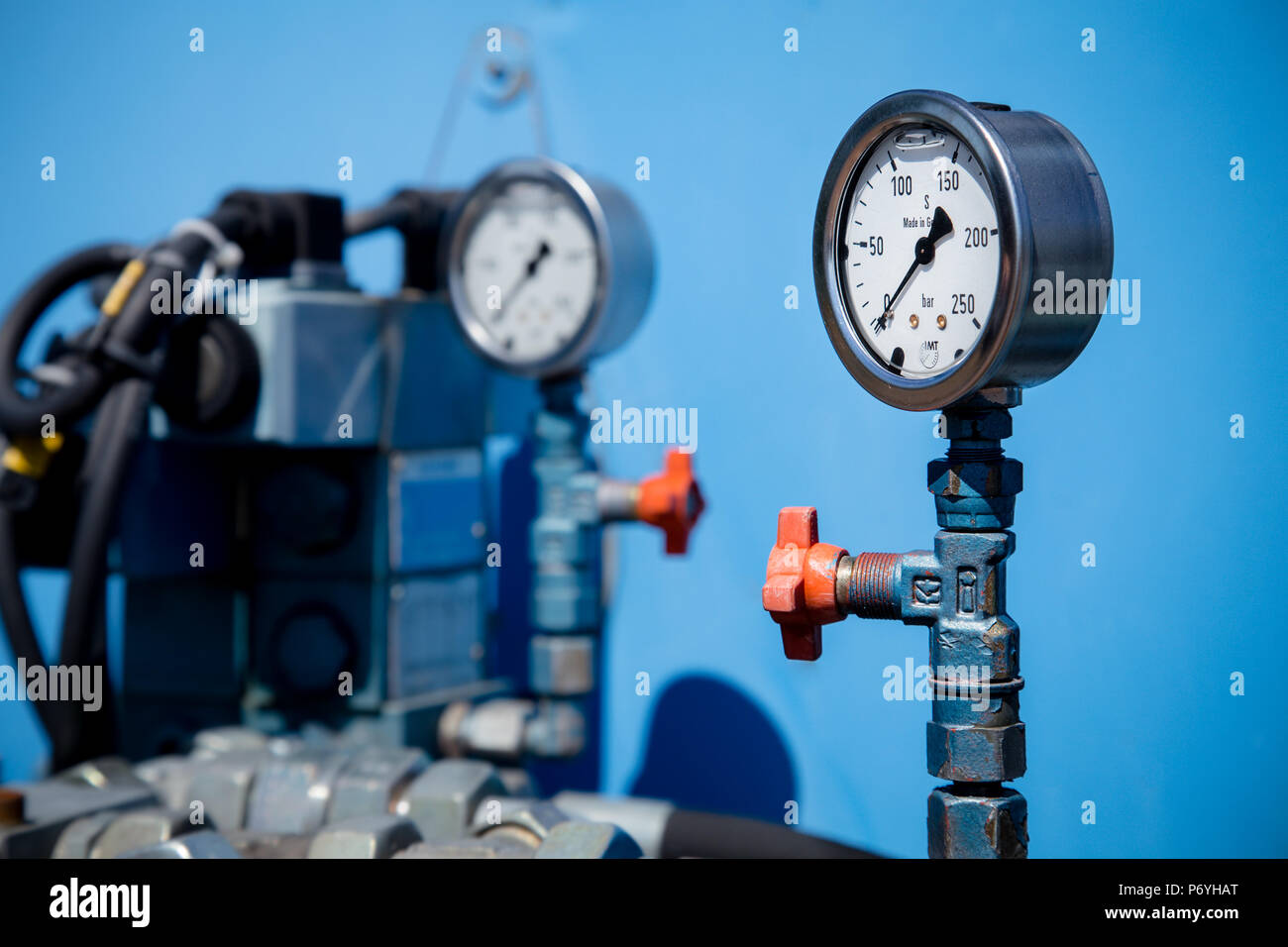 Two pressure gauges on blue background Stock Photo - Alamy
